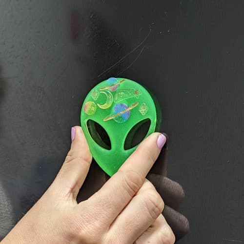 Resin-mixed-with-dye-and-glow-in-the-dark-powder-poured-into-alien-mold ...