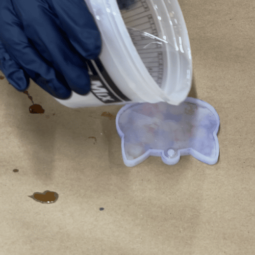 Resin-being-poured-into-a-cat-face-shaped-mold - Resin Crafts Blog