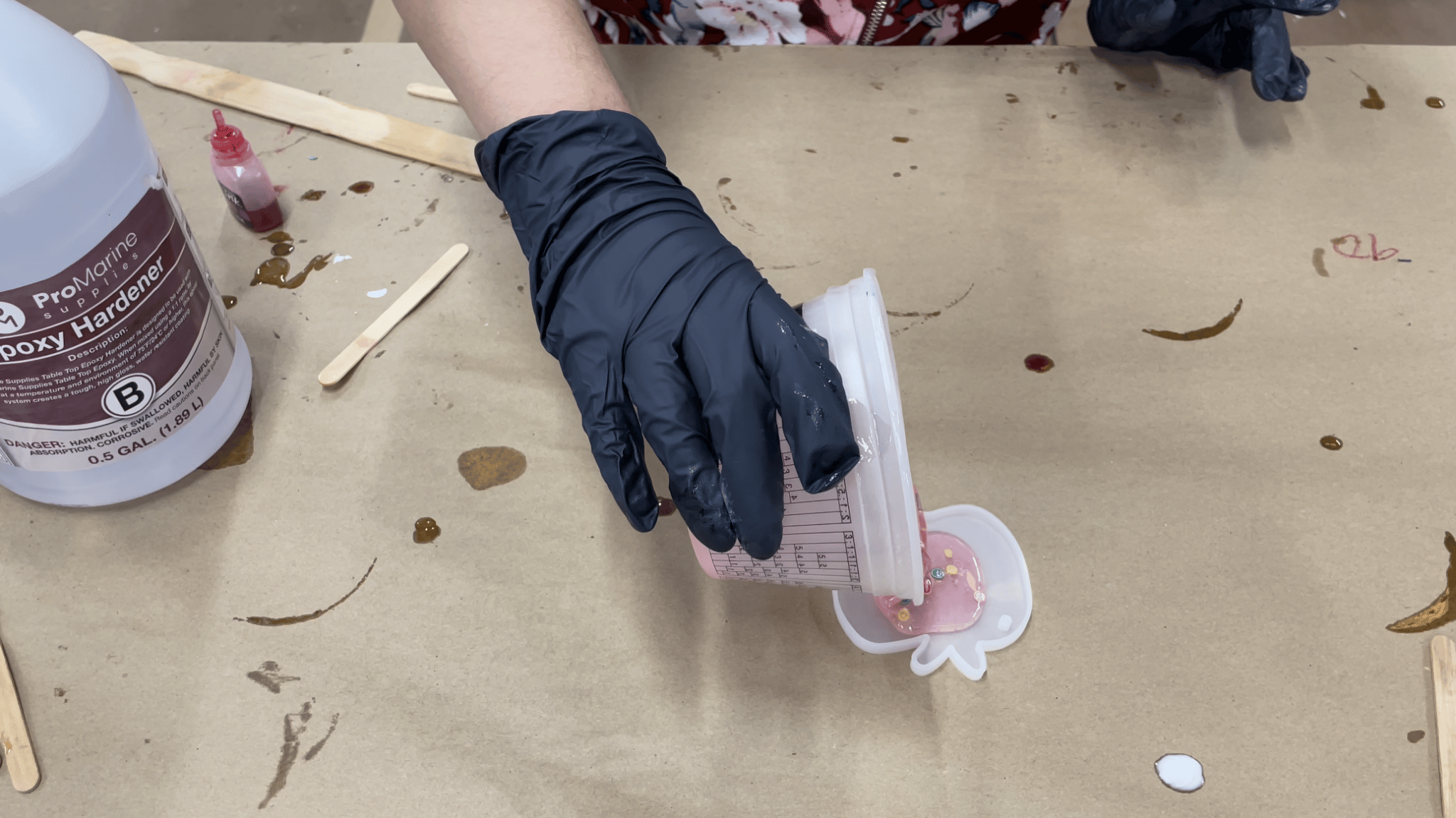 Translucent-red-resin-and-fruit-shaped-additives-poured-into-apple-mold ...